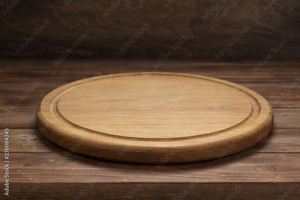 pizza cutting board at rustic wooden table in front Stock Photo | Adobe ...