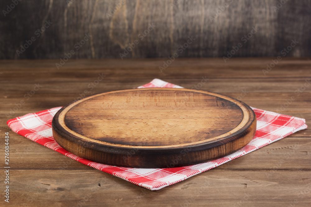 pizza cutting board at rustic wooden table in front Stock Photo | Adobe ...