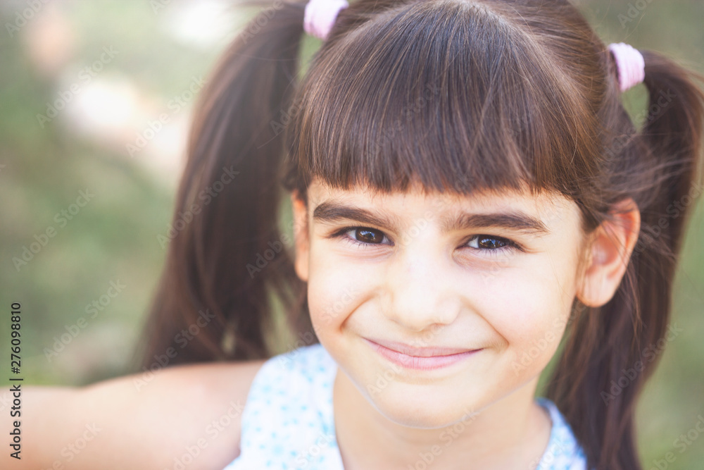 Poster Childhood concept. Portrait of a cute little girl outdoors ...