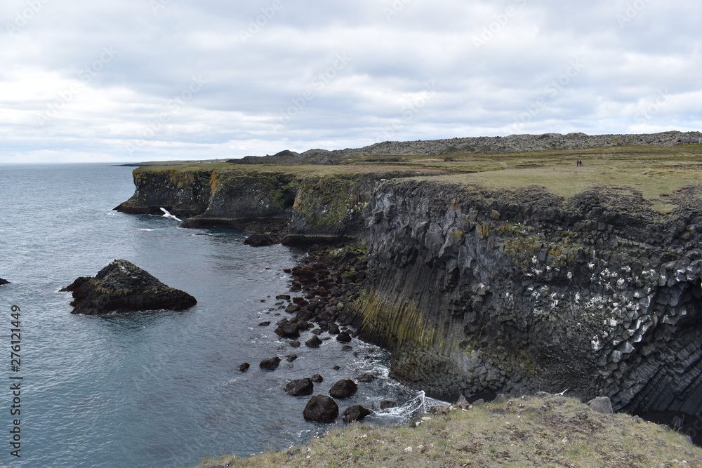 Hiking trail from Anarstapi to Hellnar with the raw ocean und big rocks and mountains in the ...