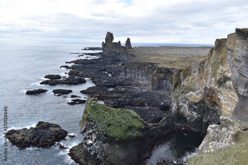 Hiking trail from Anarstapi to Hellnar with the raw ocean und big rocks and mountains in the ...