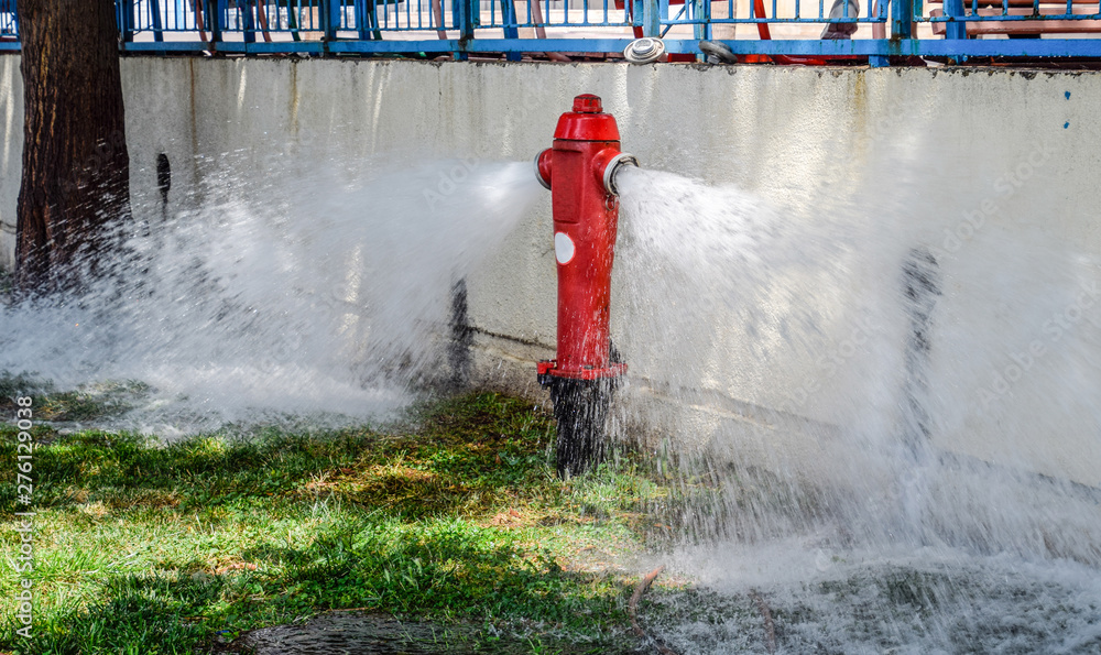 Open fire hydrant, water flows from fire hydrant. Stock Photo | Adobe Stock