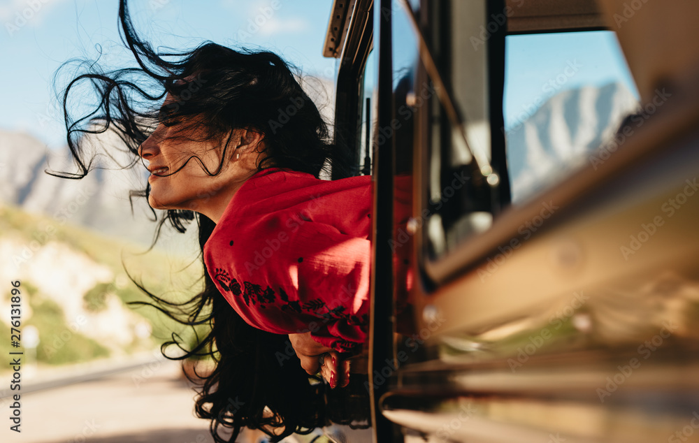 Woman enjoying a car ride Stock Photo | Adobe Stock