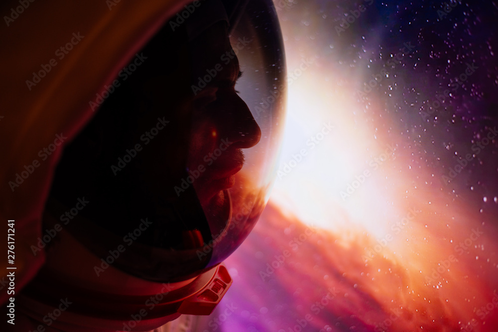 Astronaut looking deep space, galaxy and planets from the window of his ...