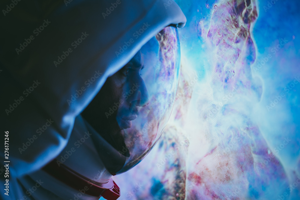 Astronaut looking deep space, galaxy and planets from the window of his ...