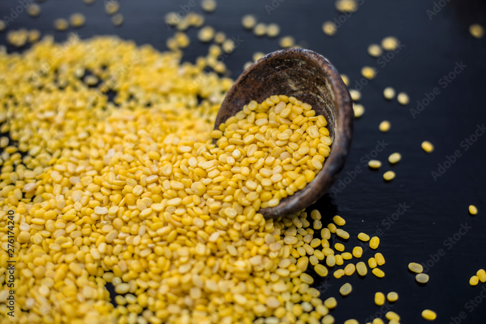 Unskinned split mung dal or moong dal in a black colored clay bowl on ...