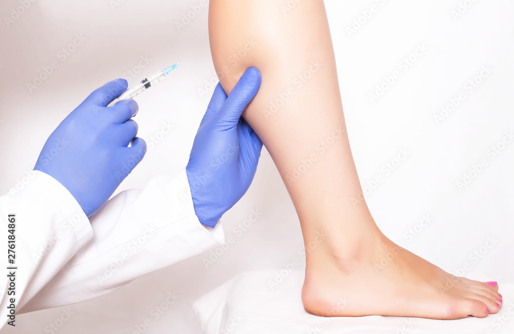 Doctor cosmetologist makes rejuvenation beauty injection to the calf ...