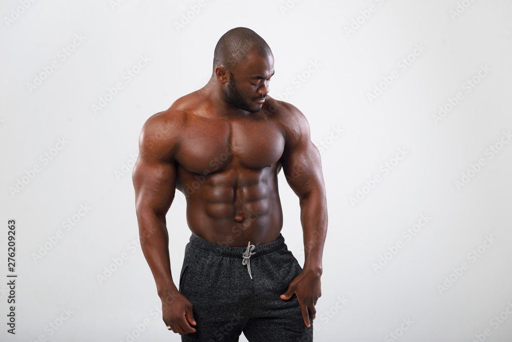 African American Athlete posing in studio. Shows body muscles Stock ...