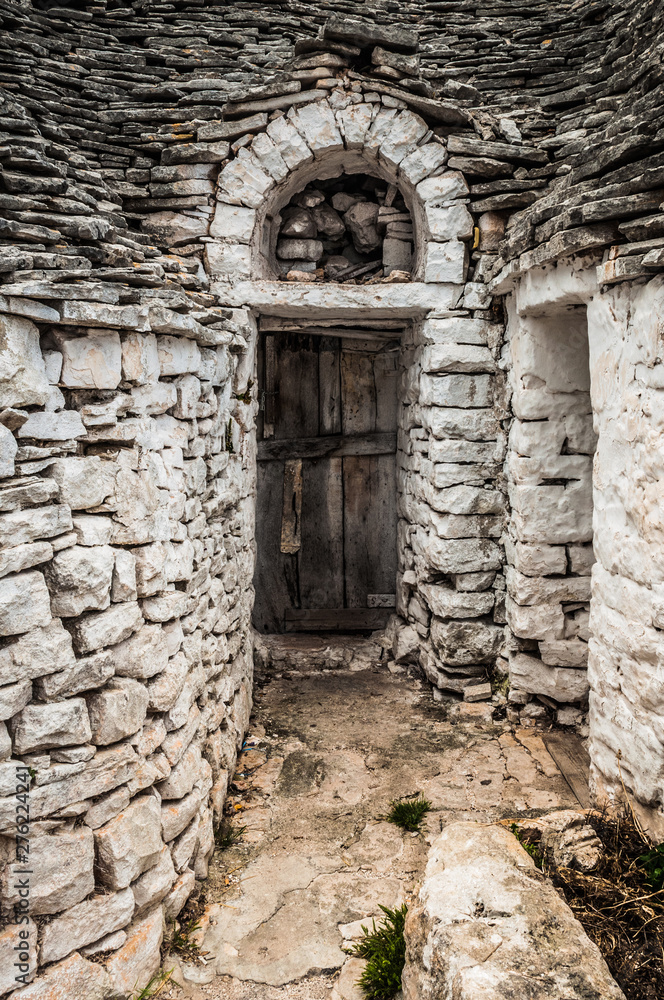 Ancient cave entrance with abandonned door between stone walls Stock ...