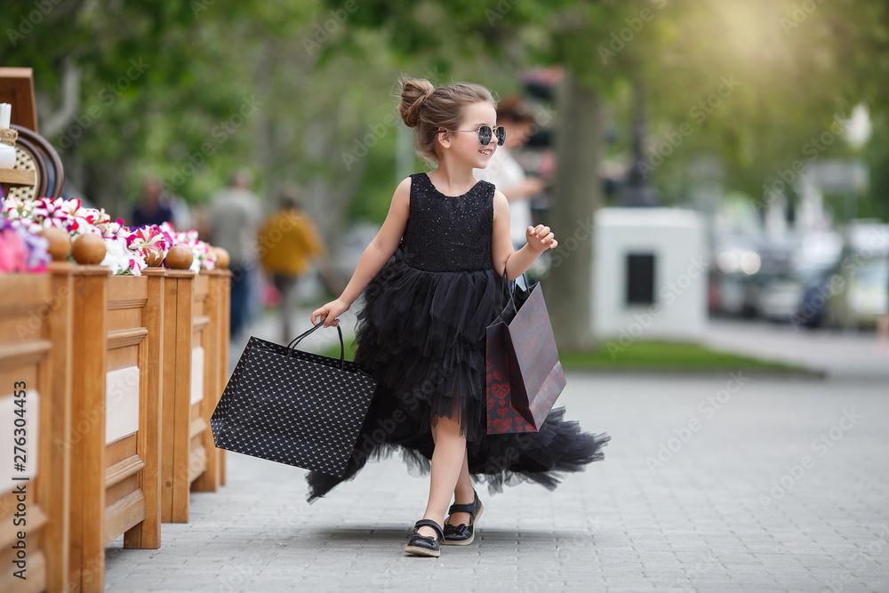 Cute little caucasian girl child having shopping fun.Fashion trend ...