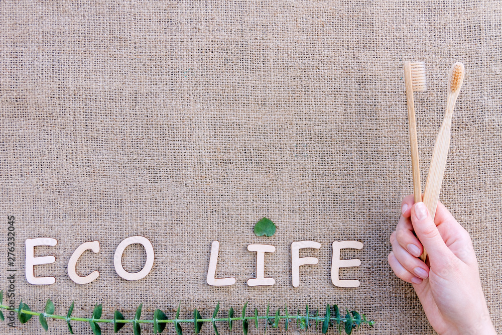 Reusable recyclable sustainable wooden toothbrushes isolated on brown ...