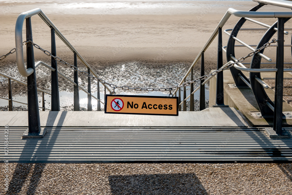Danger on the beach - safety barrier and sign at the top of the sea ...