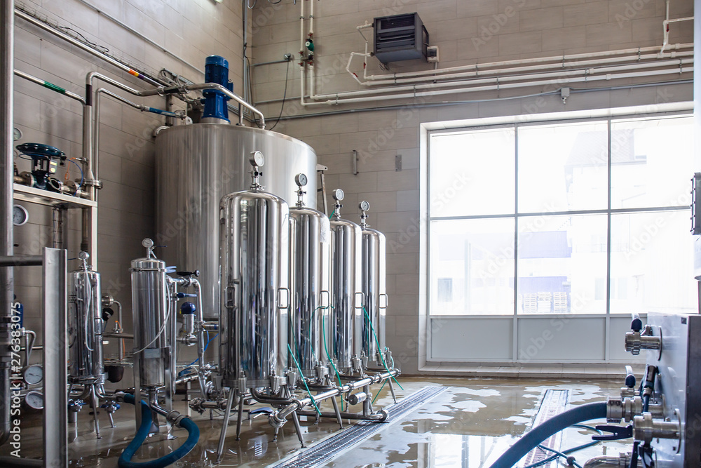 Large reservoirs and tanks and pipes with manometers in modern juice ...