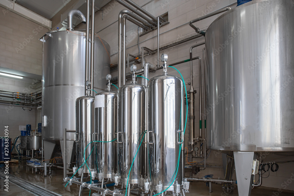 Large reservoirs and tanks and pipes with manometers in modern juice ...