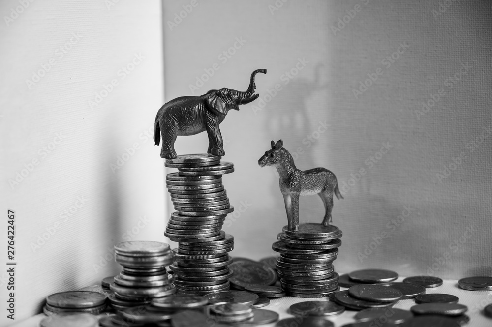 Elephant and donkey on top of stacked coins Stock Photo | Adobe Stock
