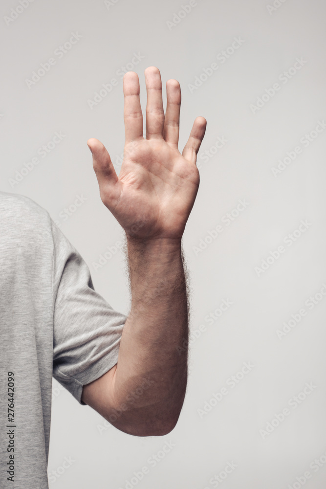 partial view of man showing stop gesture isolated on grey, human ...