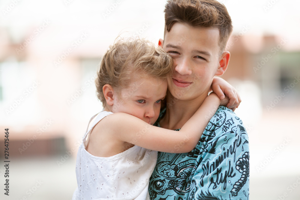 Older Brother And Sister Hugging