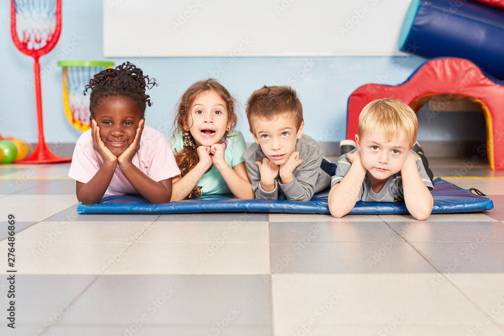 Four kids on a mat in the gym Stock Photo | Adobe Stock