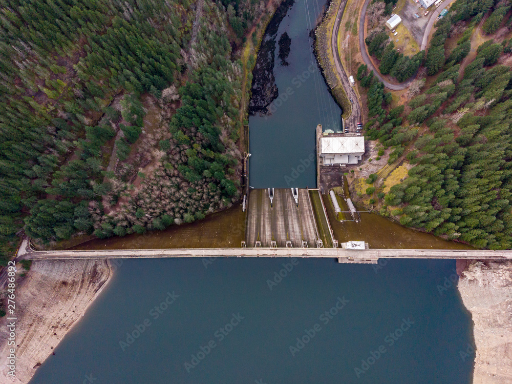 Aerial top down view at a dam of hydro electrical station. The dam is a ...