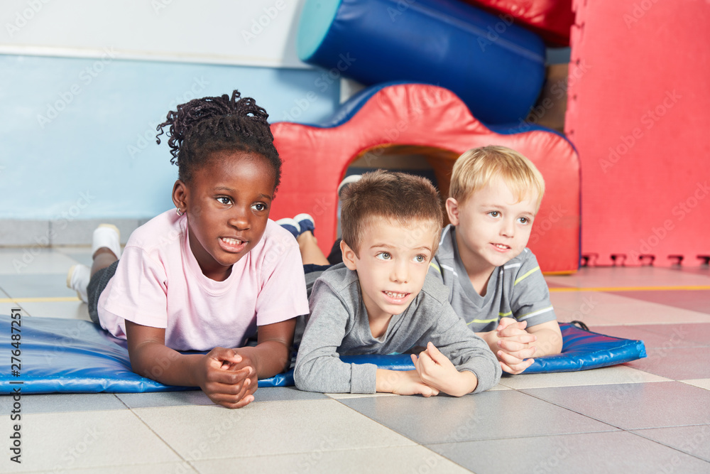 Multicultural children as friends in the gym Stock Photo | Adobe Stock