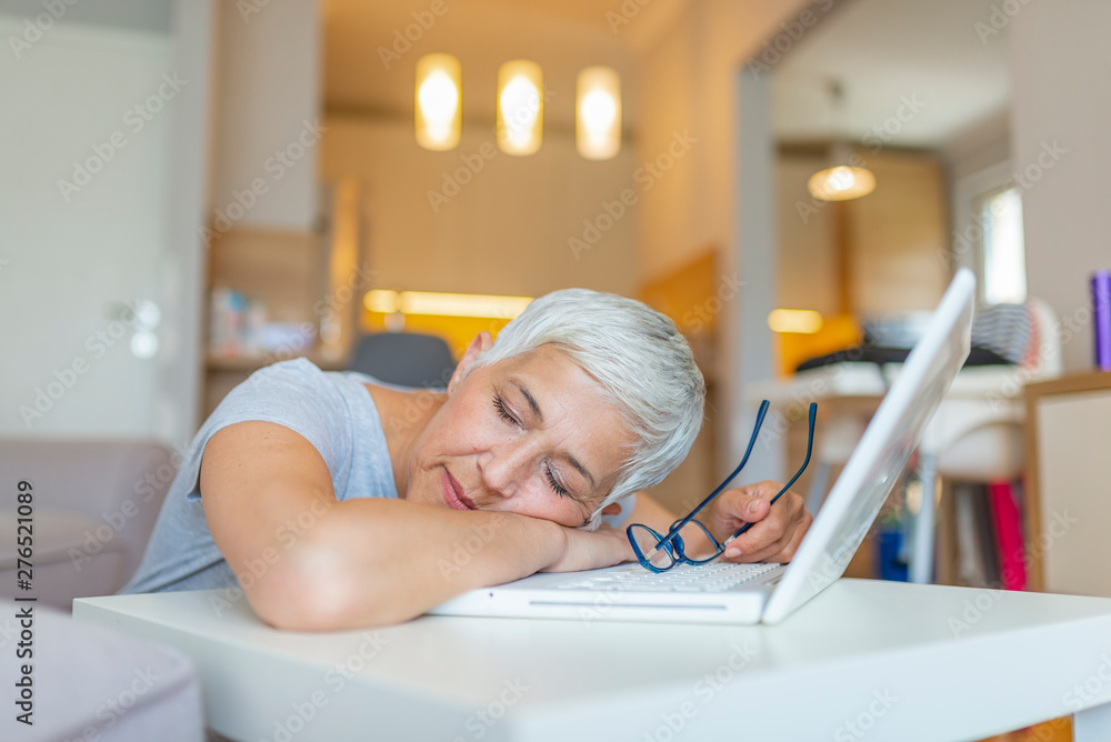 Tired overworked woman resting while she was working writing notes ...