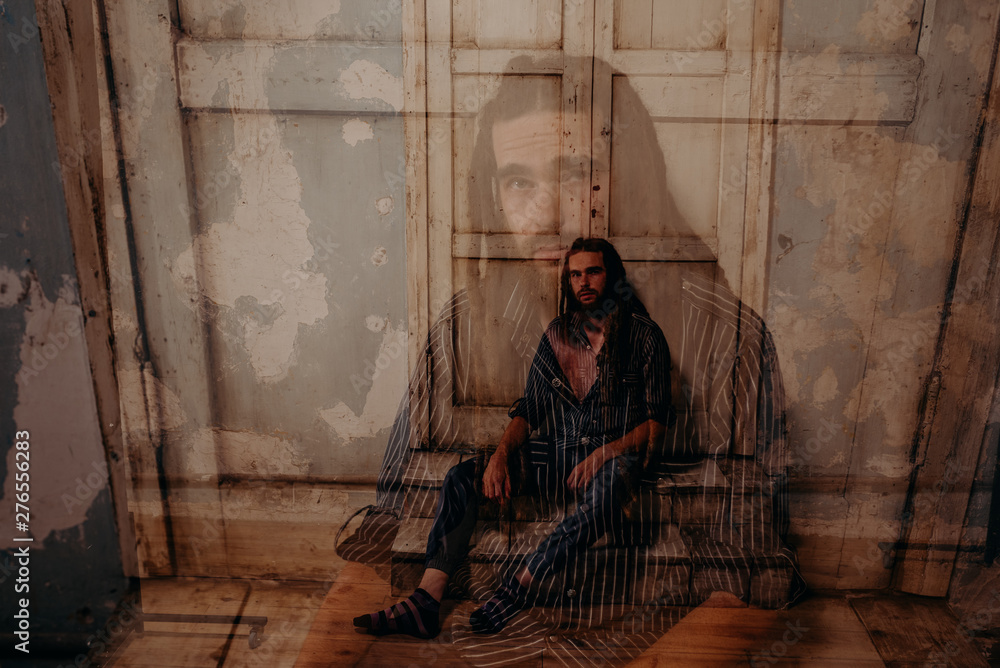 Double exposure. Enlightened cute man with a dreadlocks on his head and ...