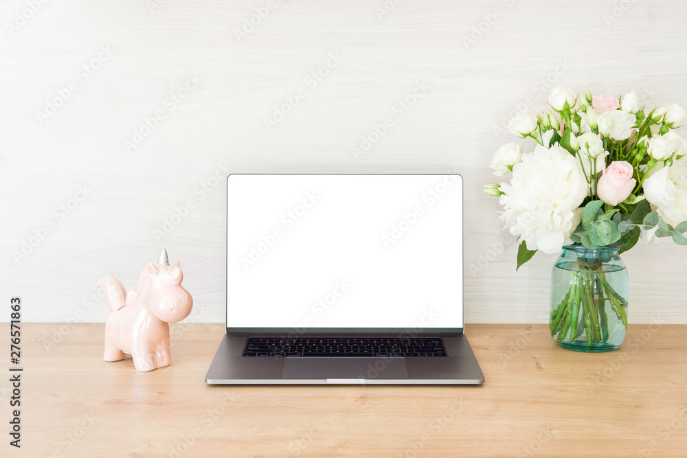 Laptop computer with blank white screen, unicorn, bouquet of flowers on ...