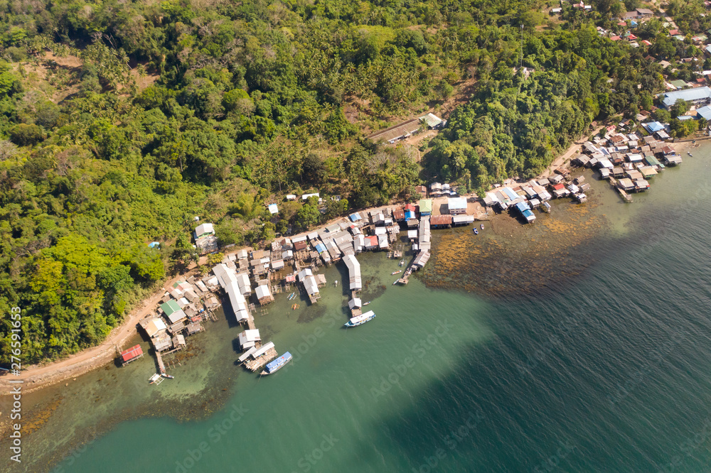 Balabac port. Houses on the water and various boats in the bay, view ...