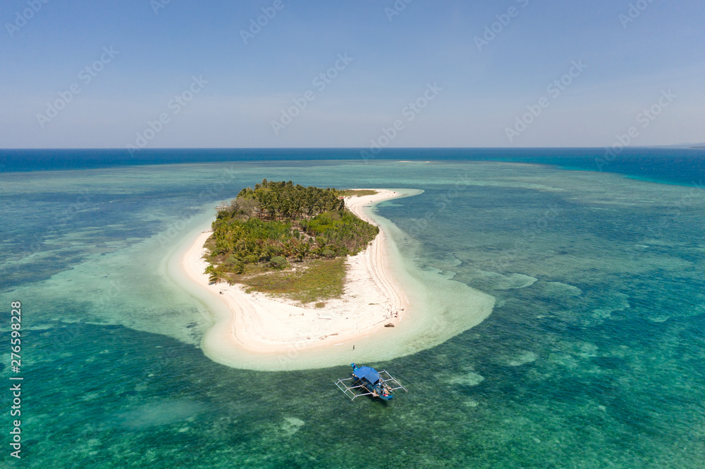 Tropical island Canimeran with sandy beach in the blue sea with coral ...