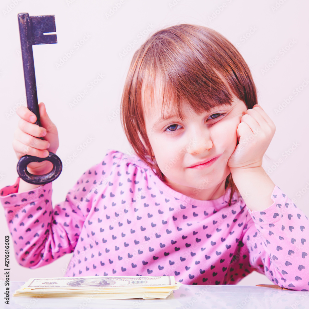 Key to success. Cute little girl holding key as symbol of wealth and ...