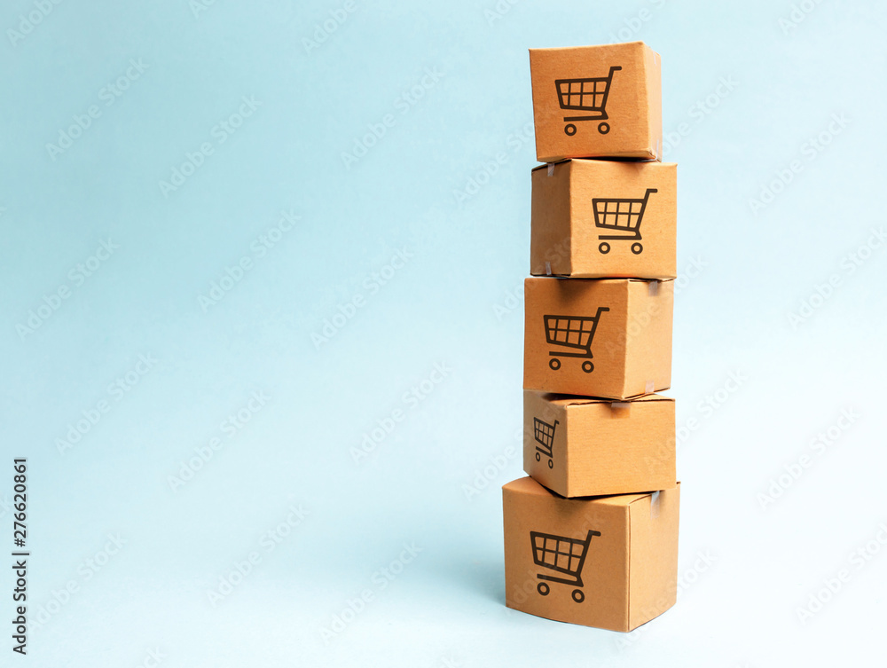 Tower of cardboard boxes with pattern of shopping carts on a blue ...