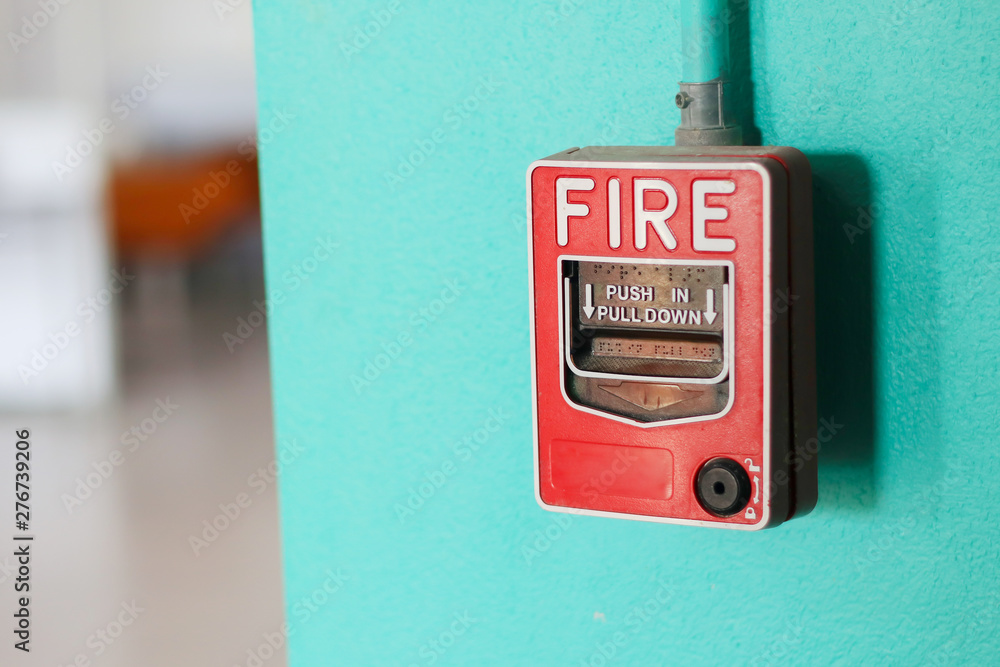 Fire alarm switch on the green wall in factory. Stock Photo | Adobe Stock