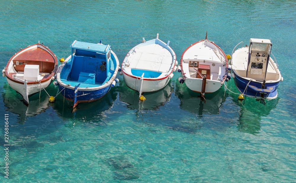 Five boats on buoys in the clear water of Puglia Italy. Stock Photo ...