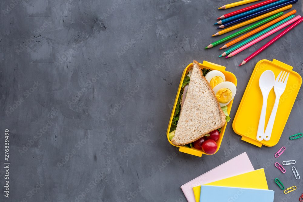 School supplies and lunch box with sandwich and vegetables. Back to ...