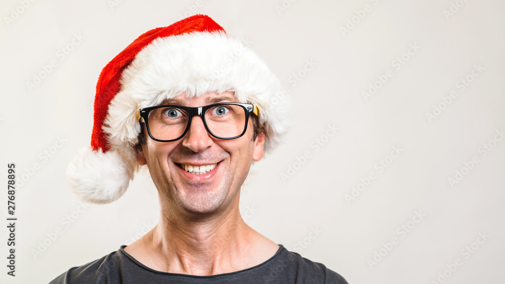 Young man in Christmas hat on grey background. Successful guy wearing ...