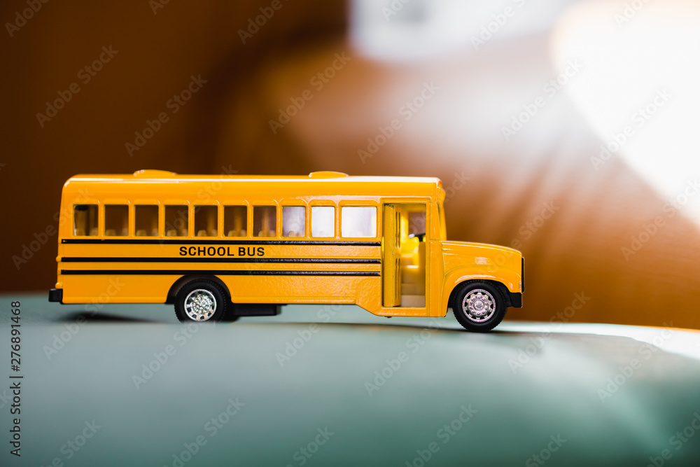 Miniature yellow school bus with sunlight Stock Photo | Adobe Stock