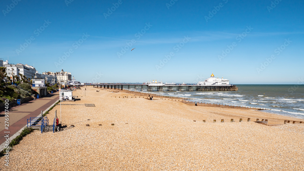 Eastbourne promenade, beach and pier, UK. A bright spring view of the ...