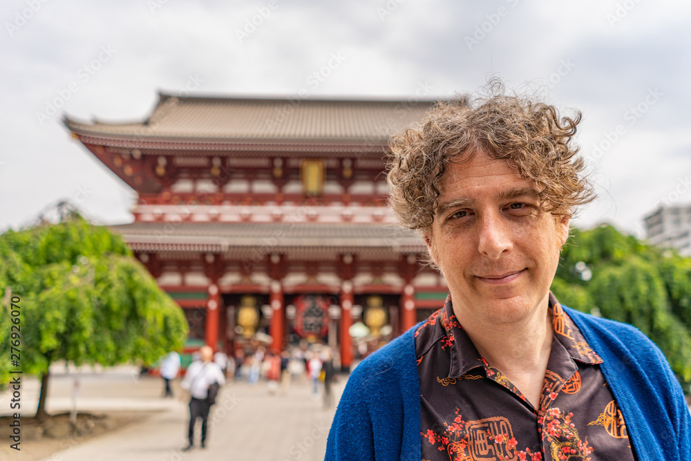 Portrait of a man traveling in Tokyo, Japan, and visiting the Senso Ji ...
