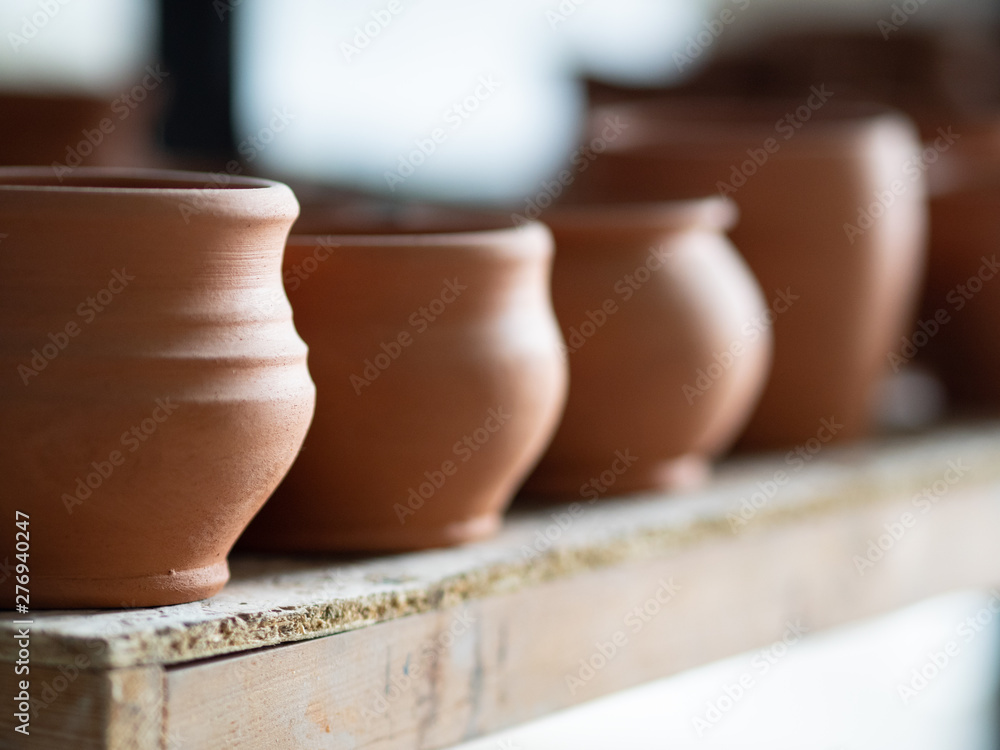 Brown handmade traditional roman replica clay pots on the shelf Stock ...