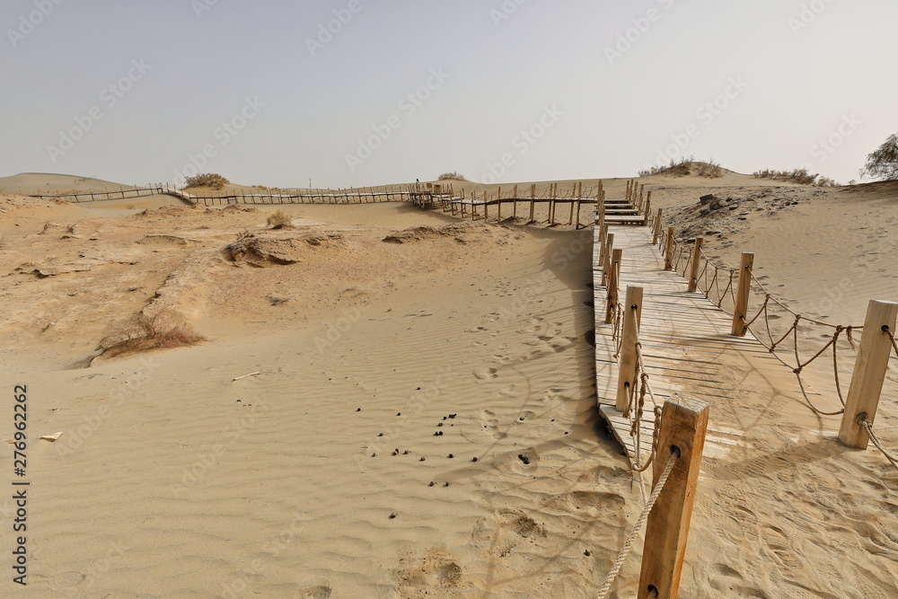 Wooden boardwalks-walkways for visiting the Rawak Stupa. Taklamakan ...