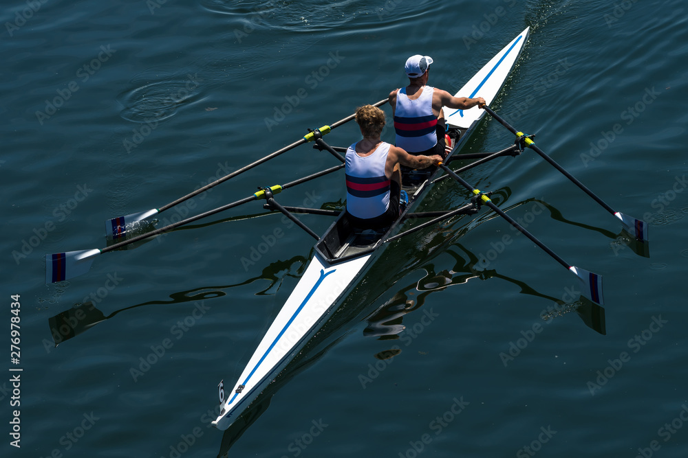 Two Male Rowers In A Double Racing Boat With Synchronous Oar Stroke ...