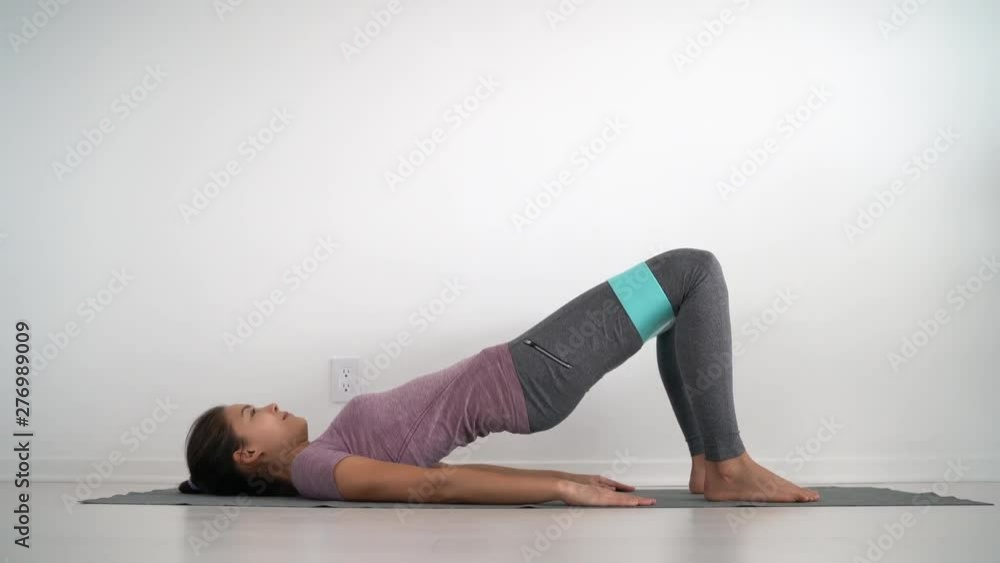 Resistance hoop band exercises Fit girl training on floor doing Glute ...