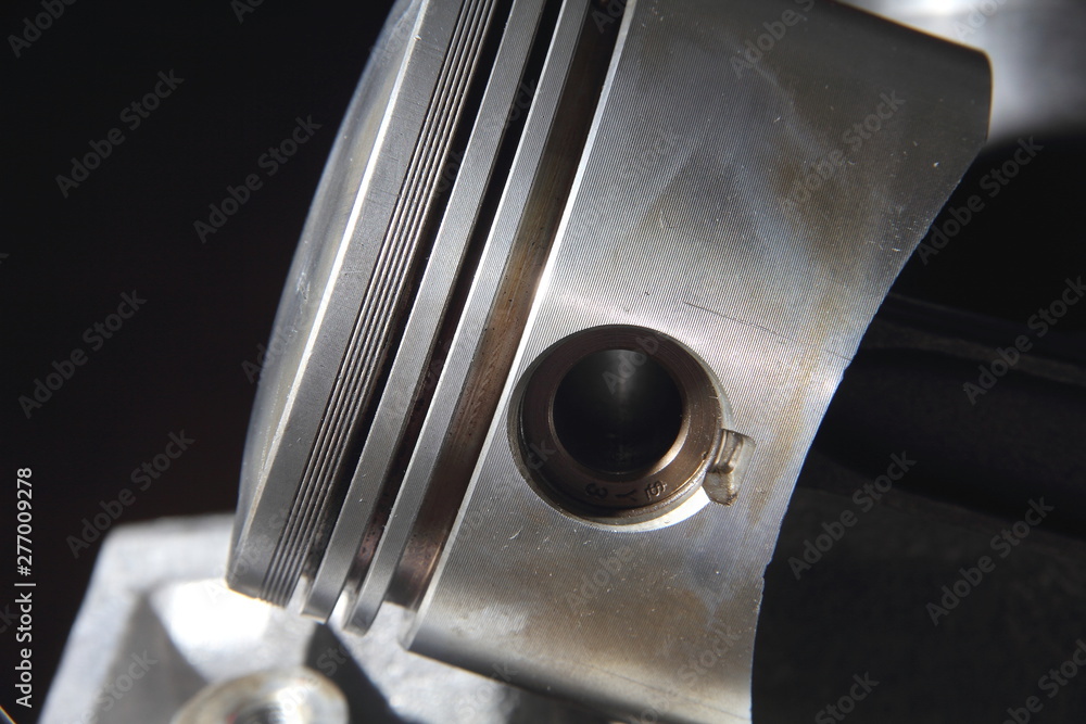 Piston of an endothermic engine showing the spaces for the elastic ...