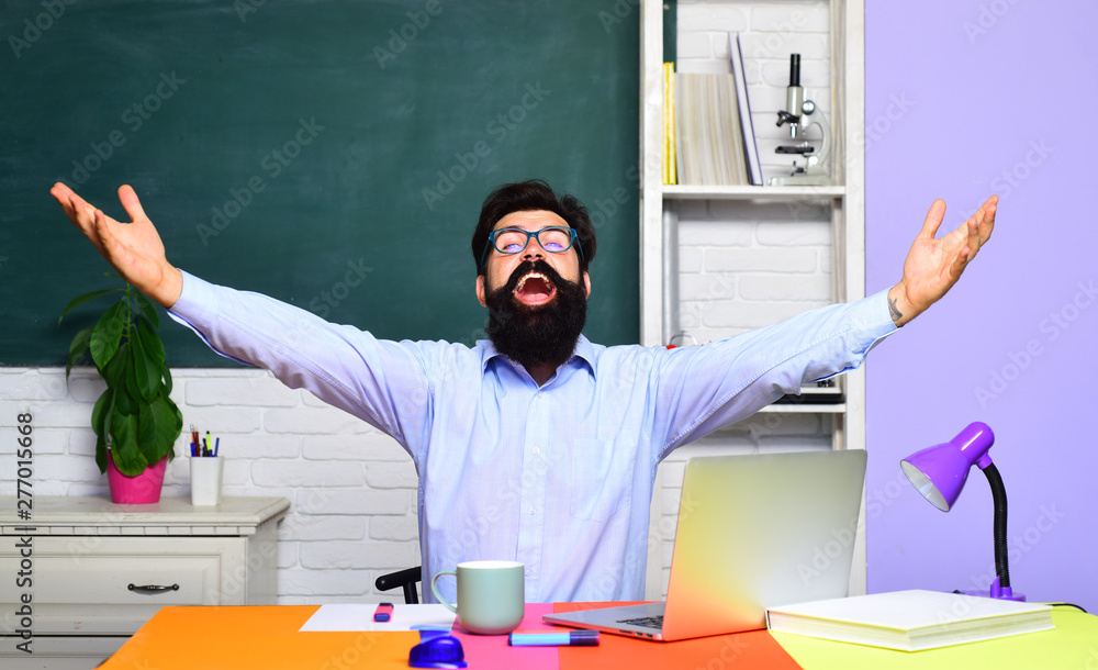 Back to school and happy time. Friendly teacher in classroom near ...