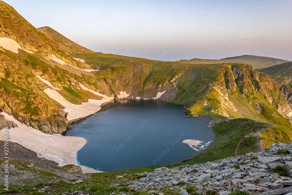 Sunrise view of The eye lake, one of the seven rila lakes in Bulgaria ...
