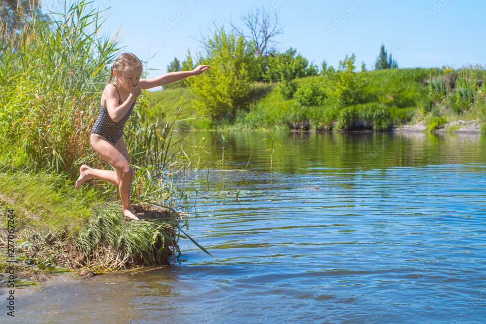 little girl running through the water with a splash . in her hands ...