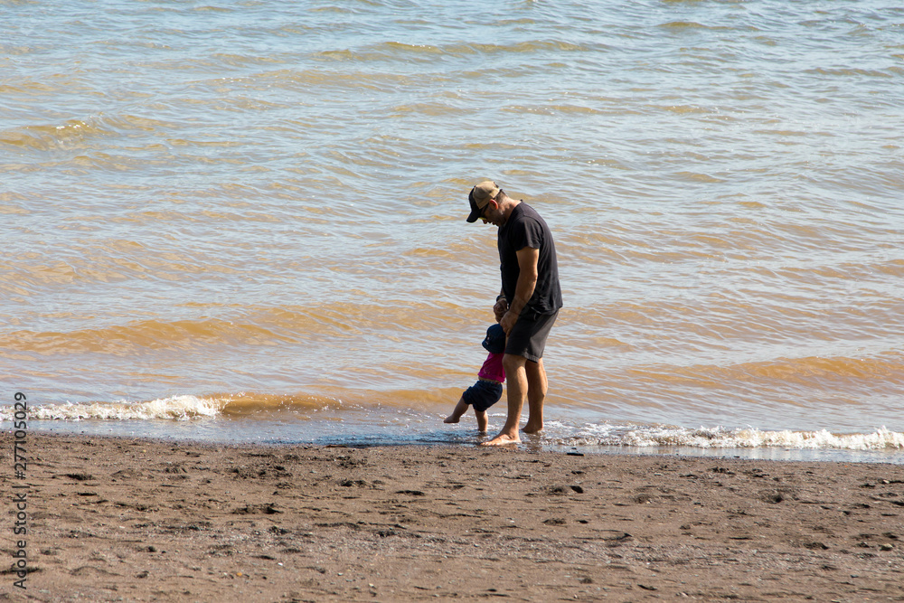 Sturdy father wearing summer clothes and sunglasses seen in profile ...
