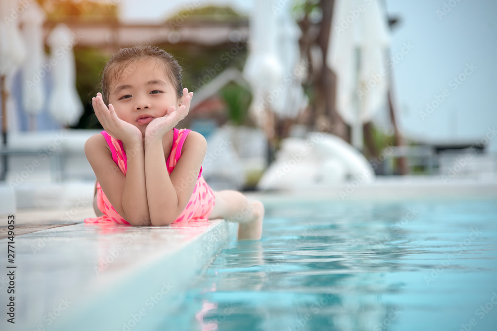 Cheerful cute girl at swimming pool on summer vacation with happiness ...