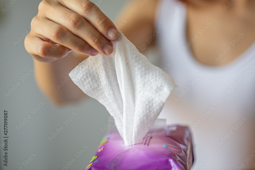 Wet wipes: woman take one wipe from package for cleaning Stock Photo ...