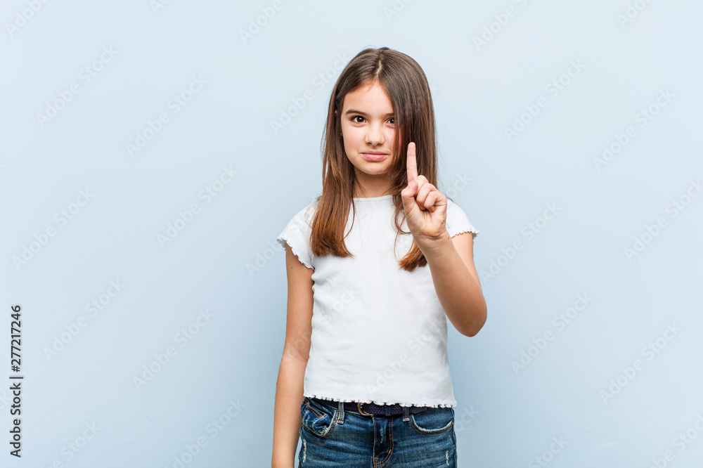 Cute girl showing number one with finger. Stock Photo | Adobe Stock